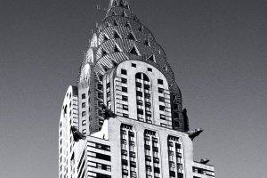 Chrysler Building Spire with Rooftops - Framed Photograph by Andrew Prokos