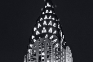 Chrysler Building Spire with Rooftops - Framed Photograph by Andrew Prokos